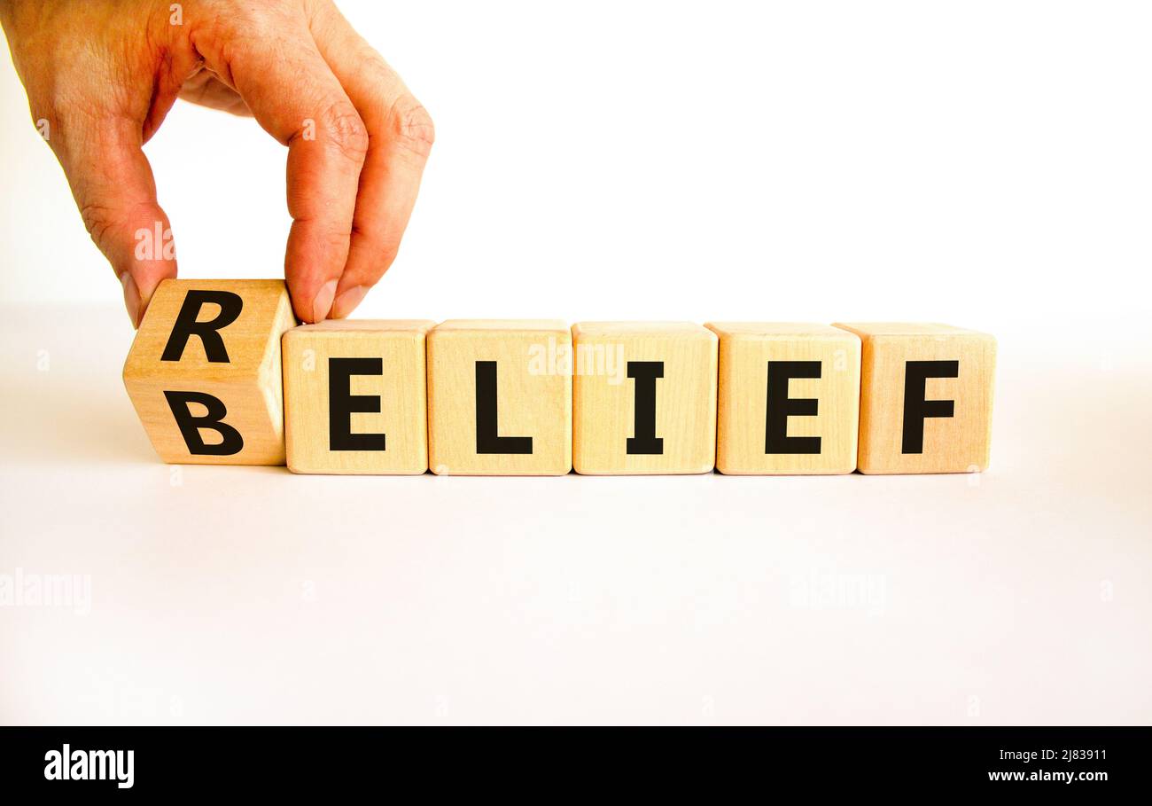 Belief or relief symbol. Businessman turns wooden cubes, changes ...