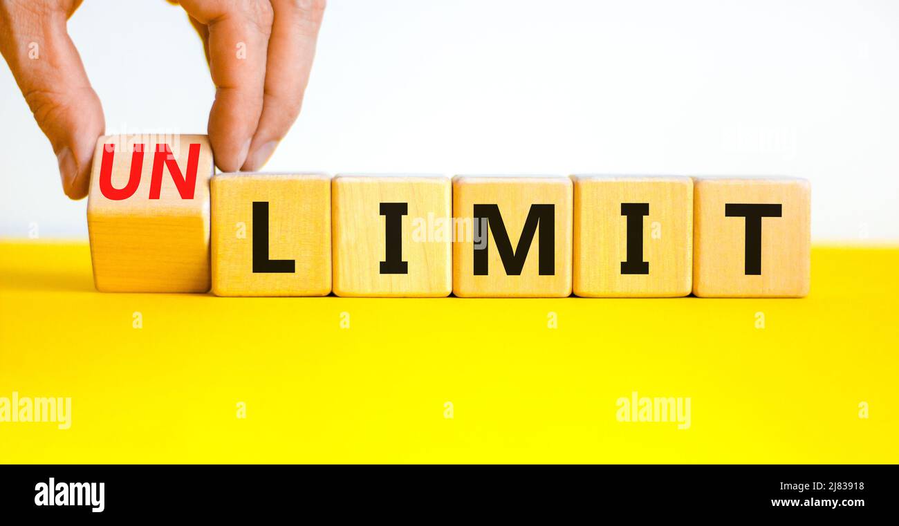 Limit or unlimit symbol. Businessman turns wooden cubes and changes the ...