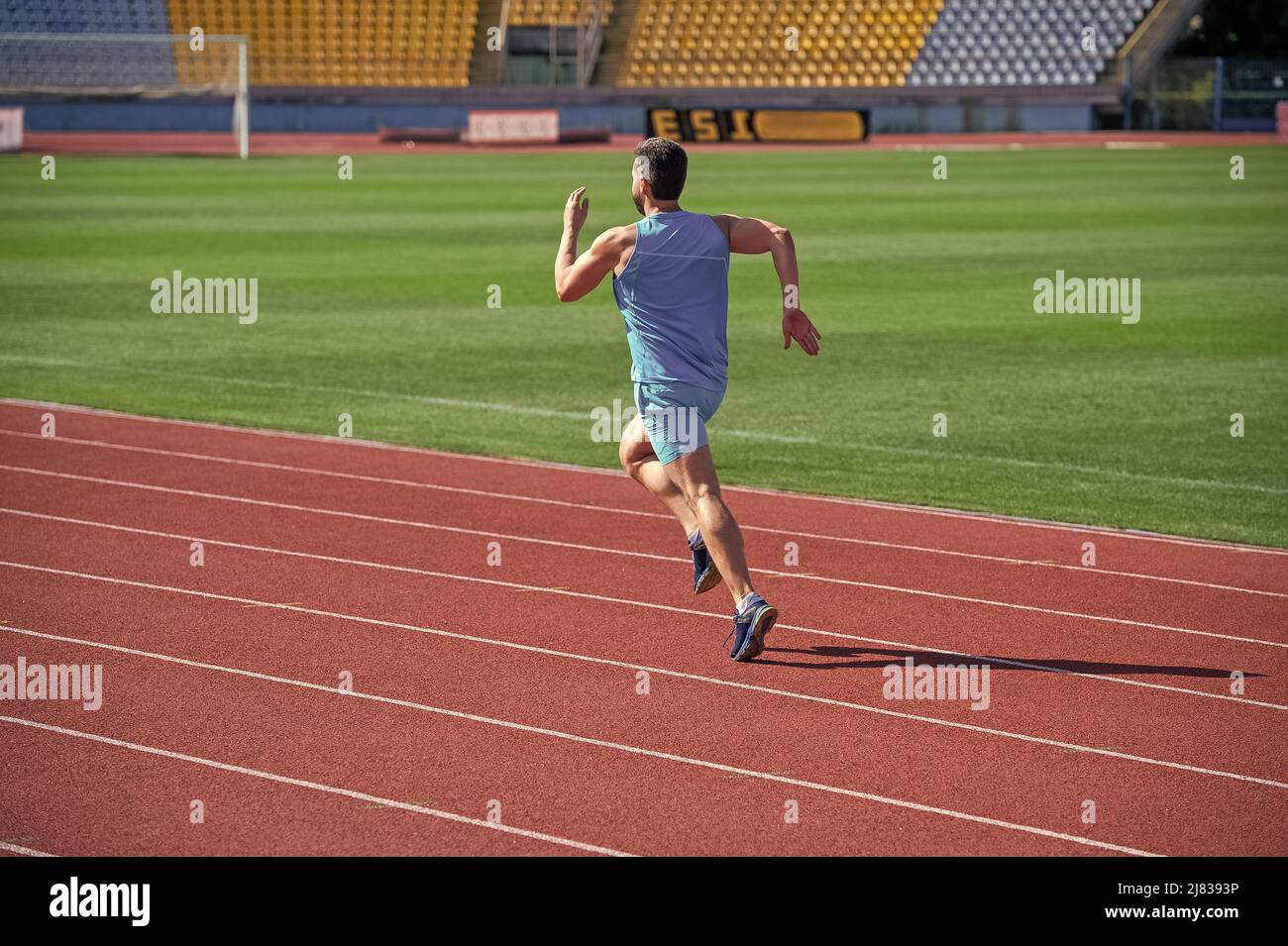aim and success. man running on stadium. sports and healthy lifestyle ...