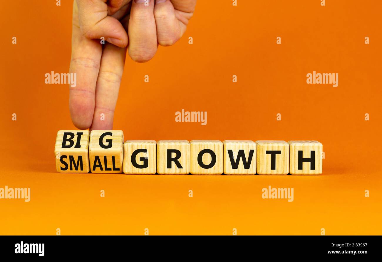 Big or small growth symbol. Businessman turns wooden cubes and changes ...