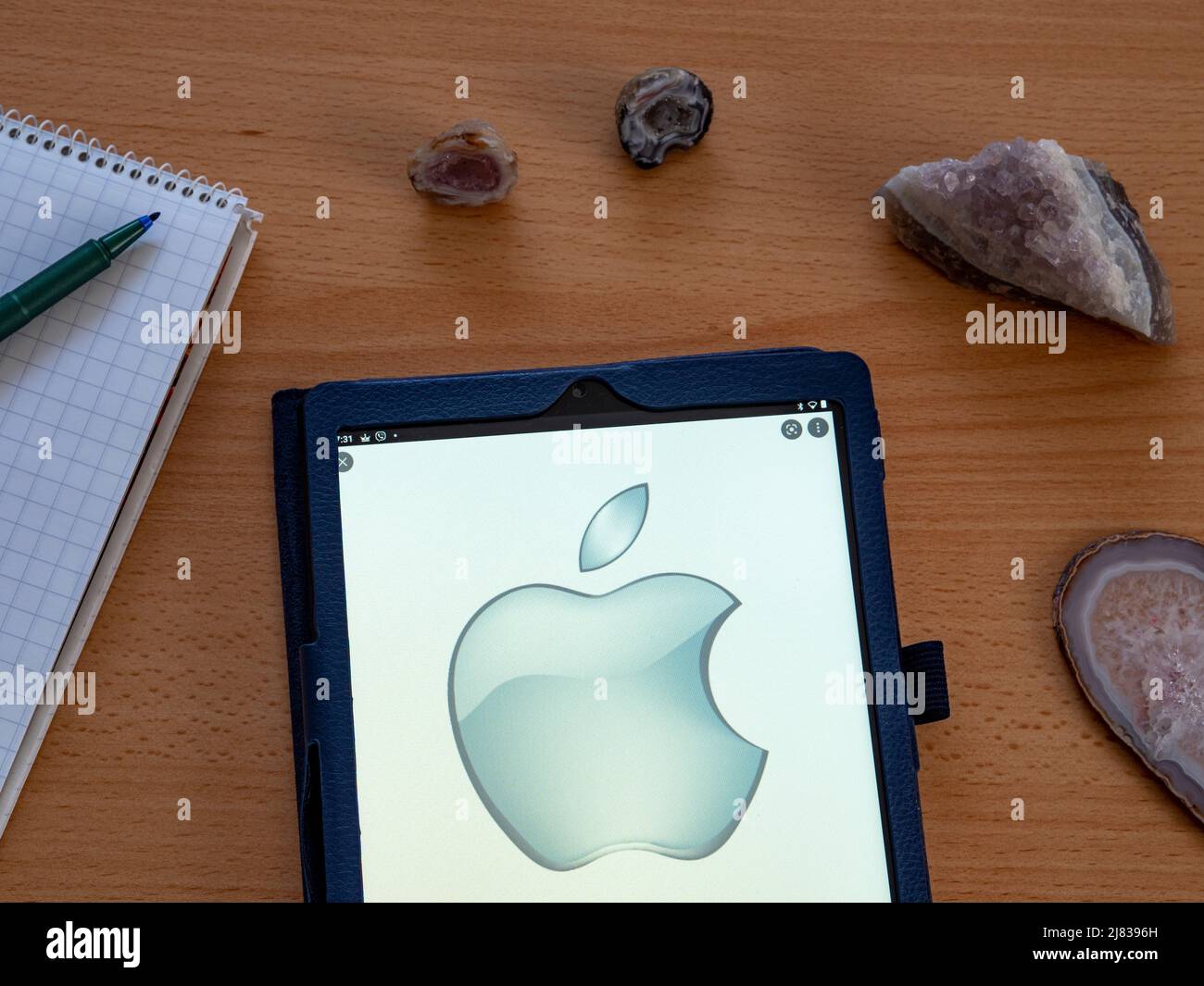 In this photo illustration Apple Inc. logo seen displayed on a tablet ...