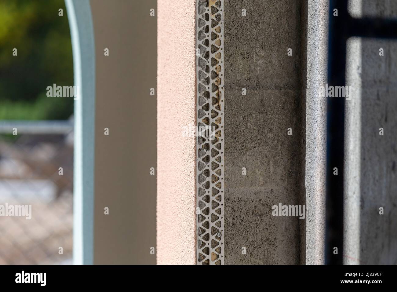 partially finished exterior wall with painted stucco exposing the ...