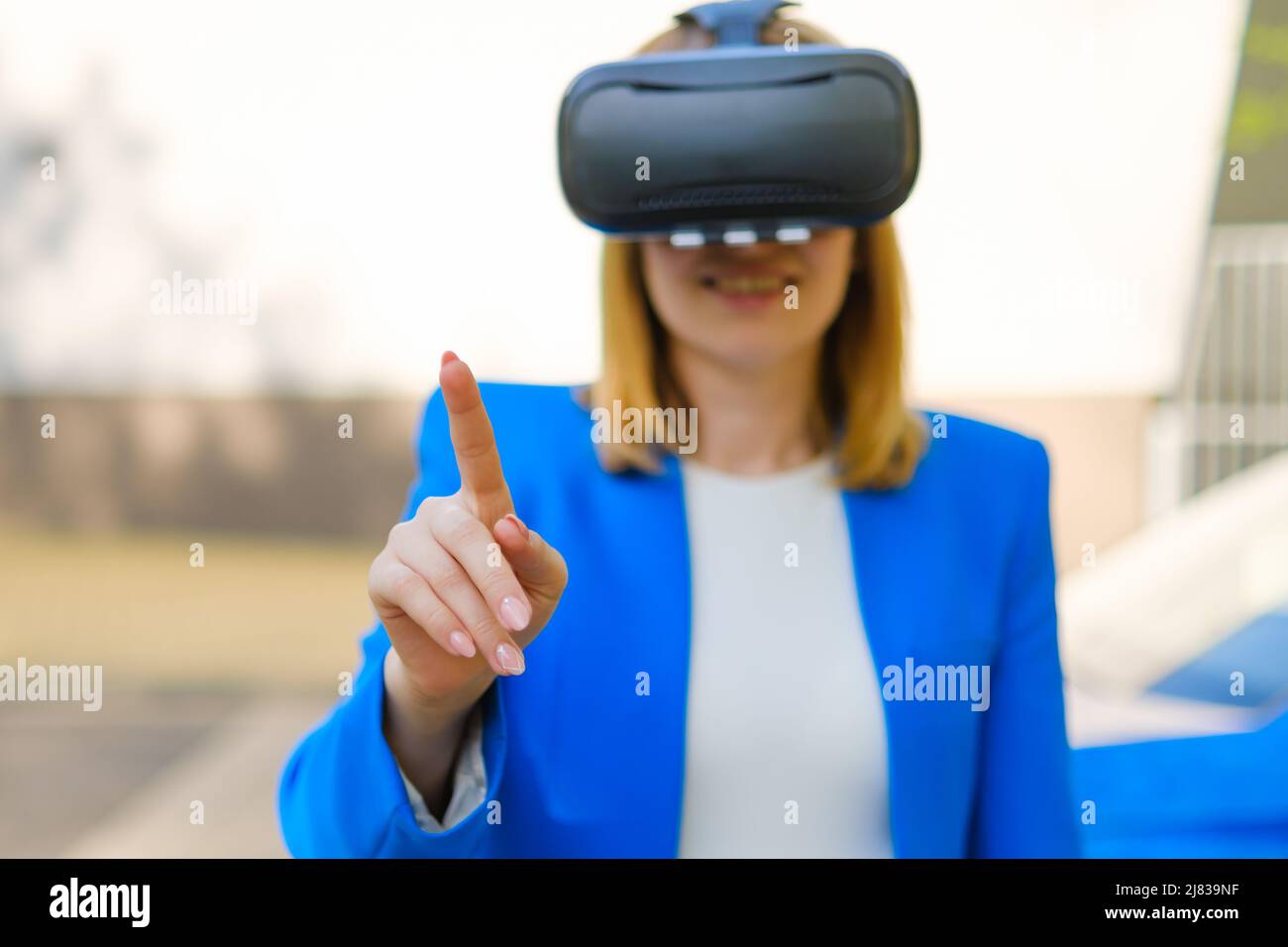 Business woman controls the virtual interface by pressing buttons with ...