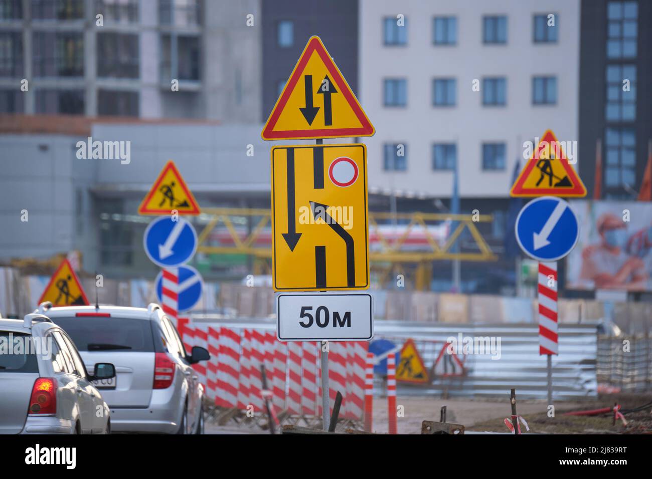 Roadworks warning traffic signs of construction work on city street and ...