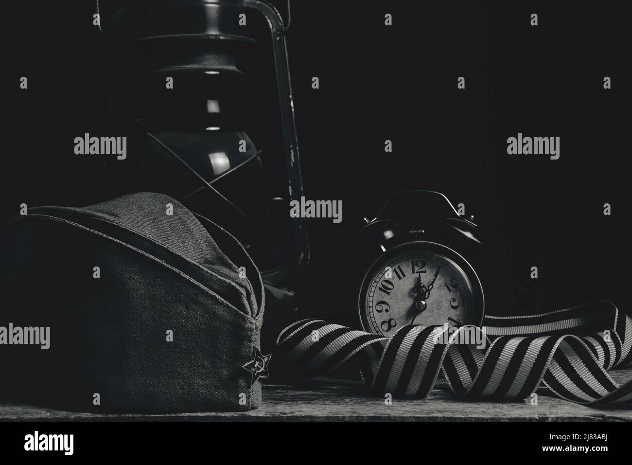 Russian soldiers cap, St. George ribbon, old retro alarm clock and ...