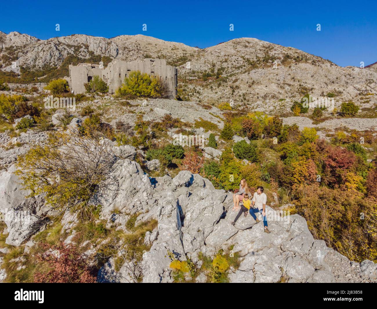 Happy family on the background of Collapsing tower of fortress Kosmac ...