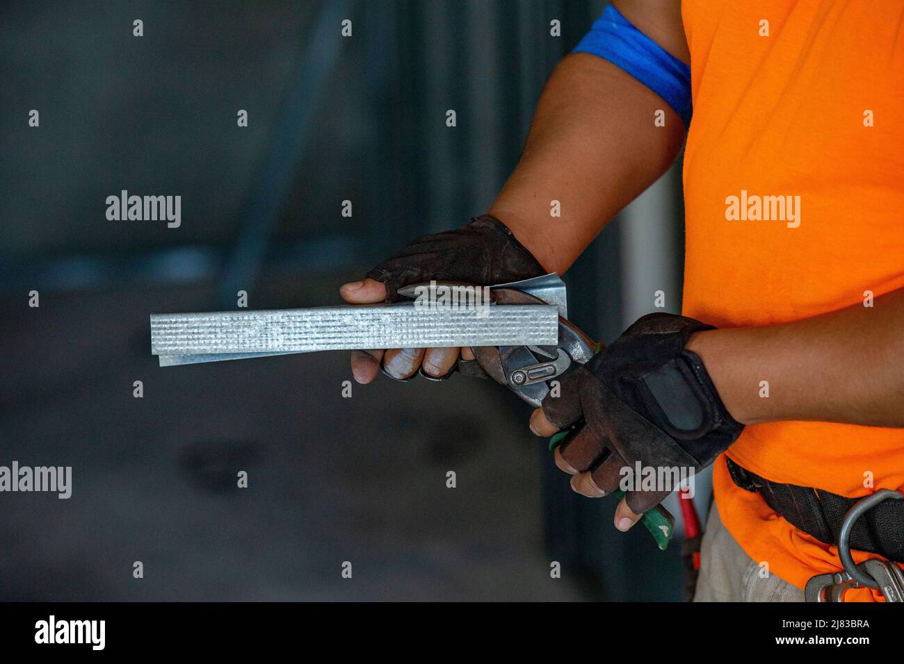 Construction worker (framer) cutting a pieces of Galvanized Steel for ...