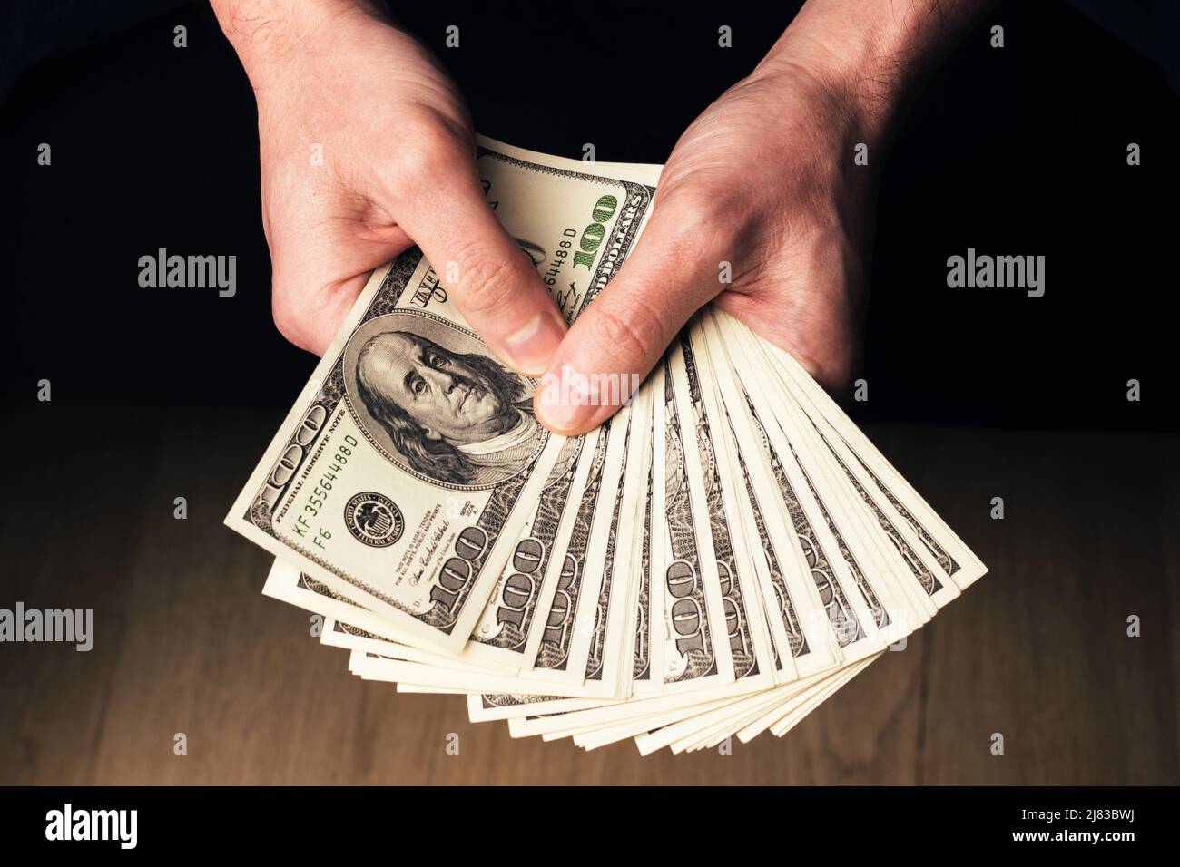 Male hands holding us dollar hi-res stock photography and images - Alamy