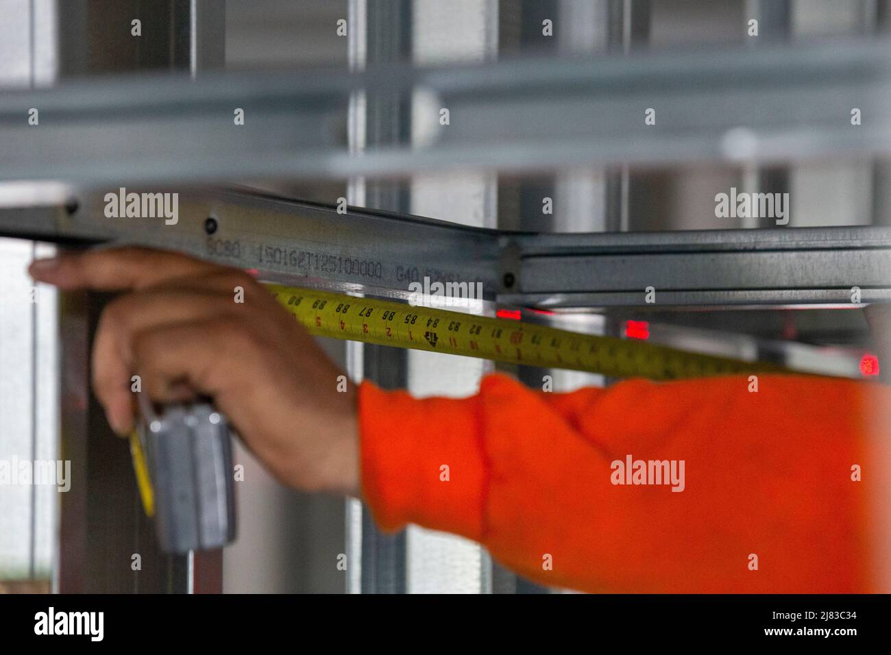 Drywall framing in progress. Measuring space for next Galvanized Steel ...