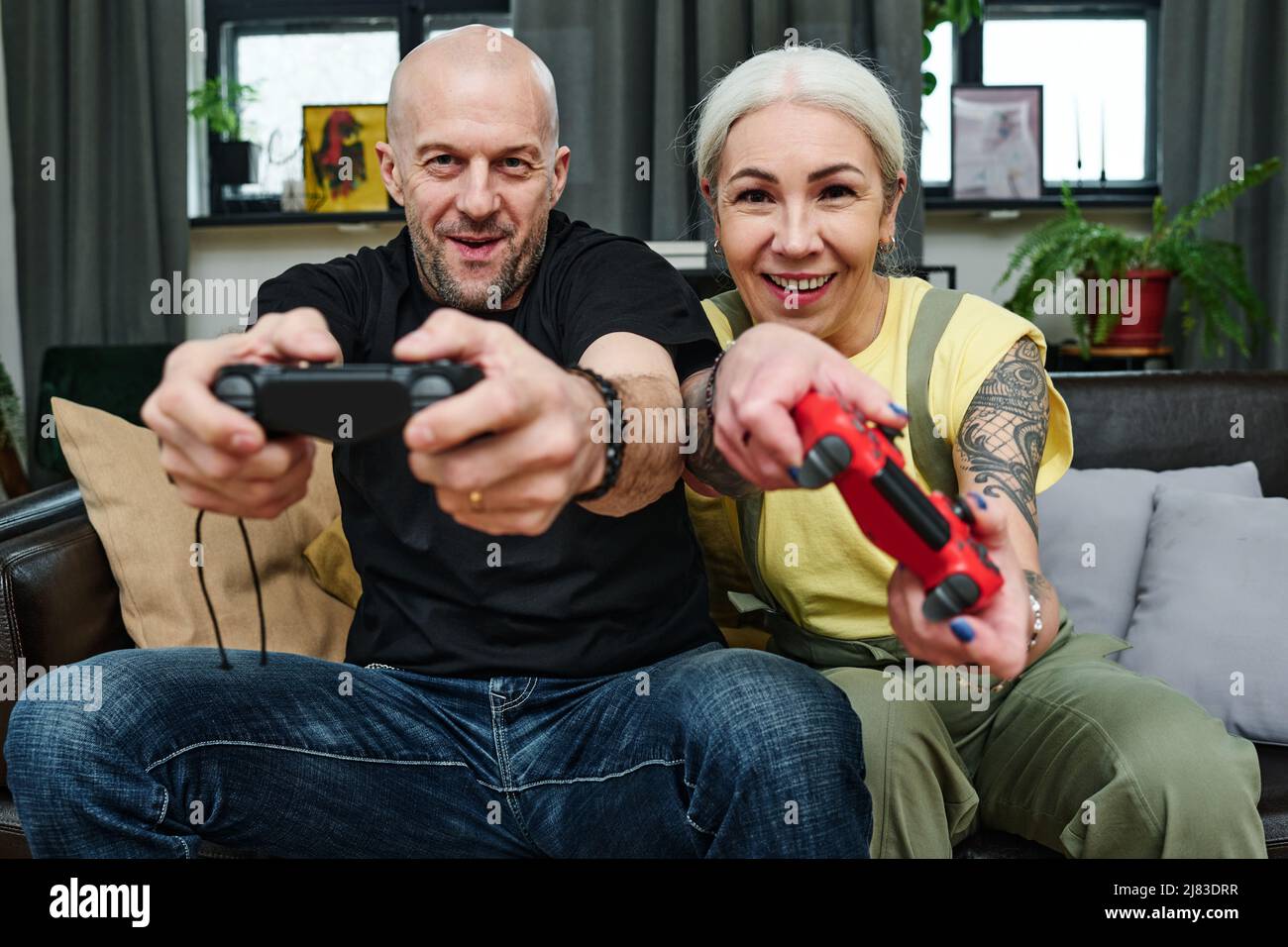 Modern mature Caucasian man and woman in love spending time at home ...