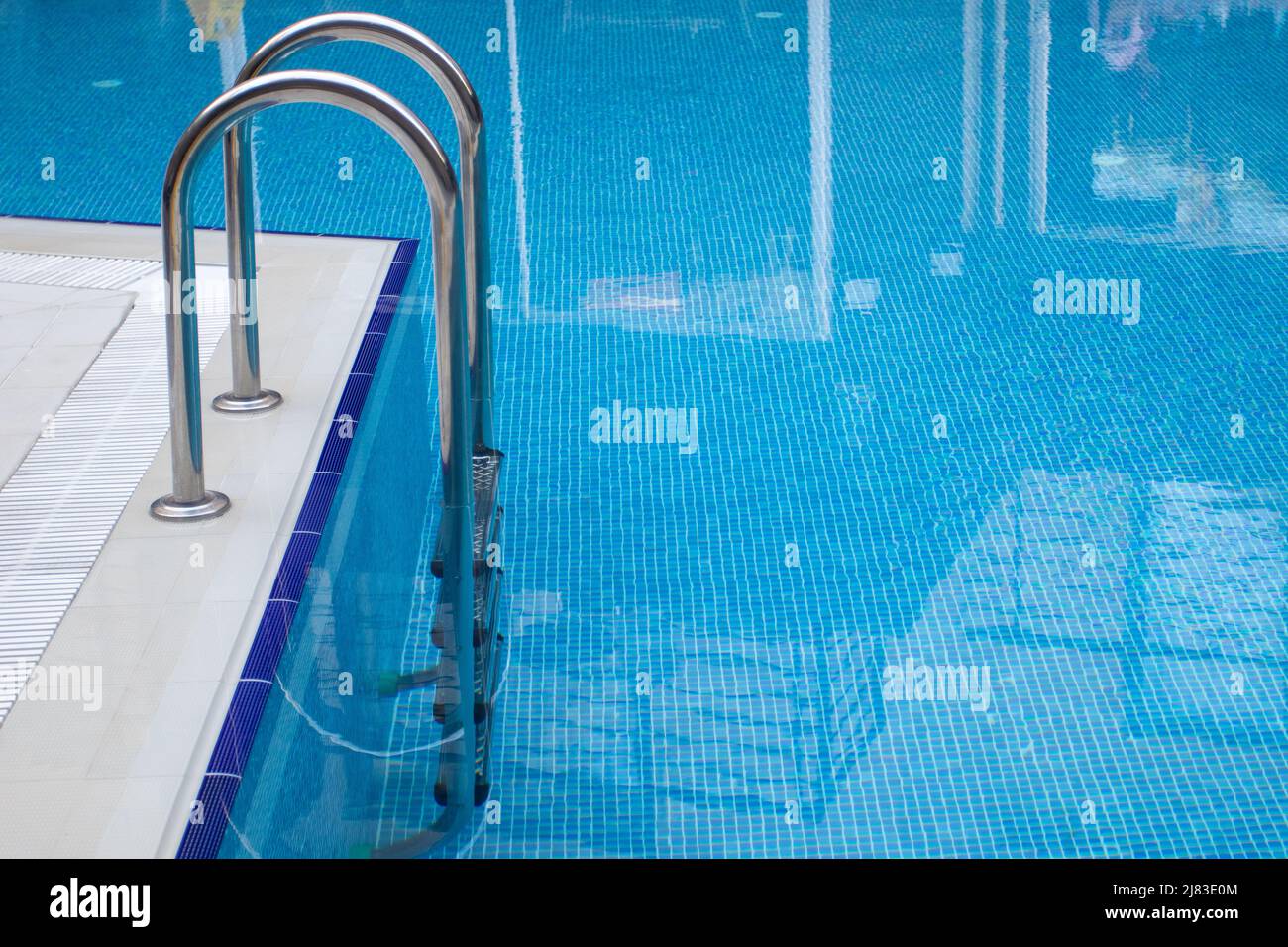 Pool handrails entrance into the pool Stock Photo - Alamy