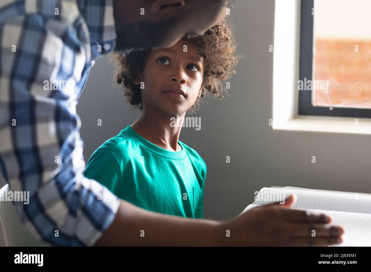 African american elementary schoolboy looking african american young ...