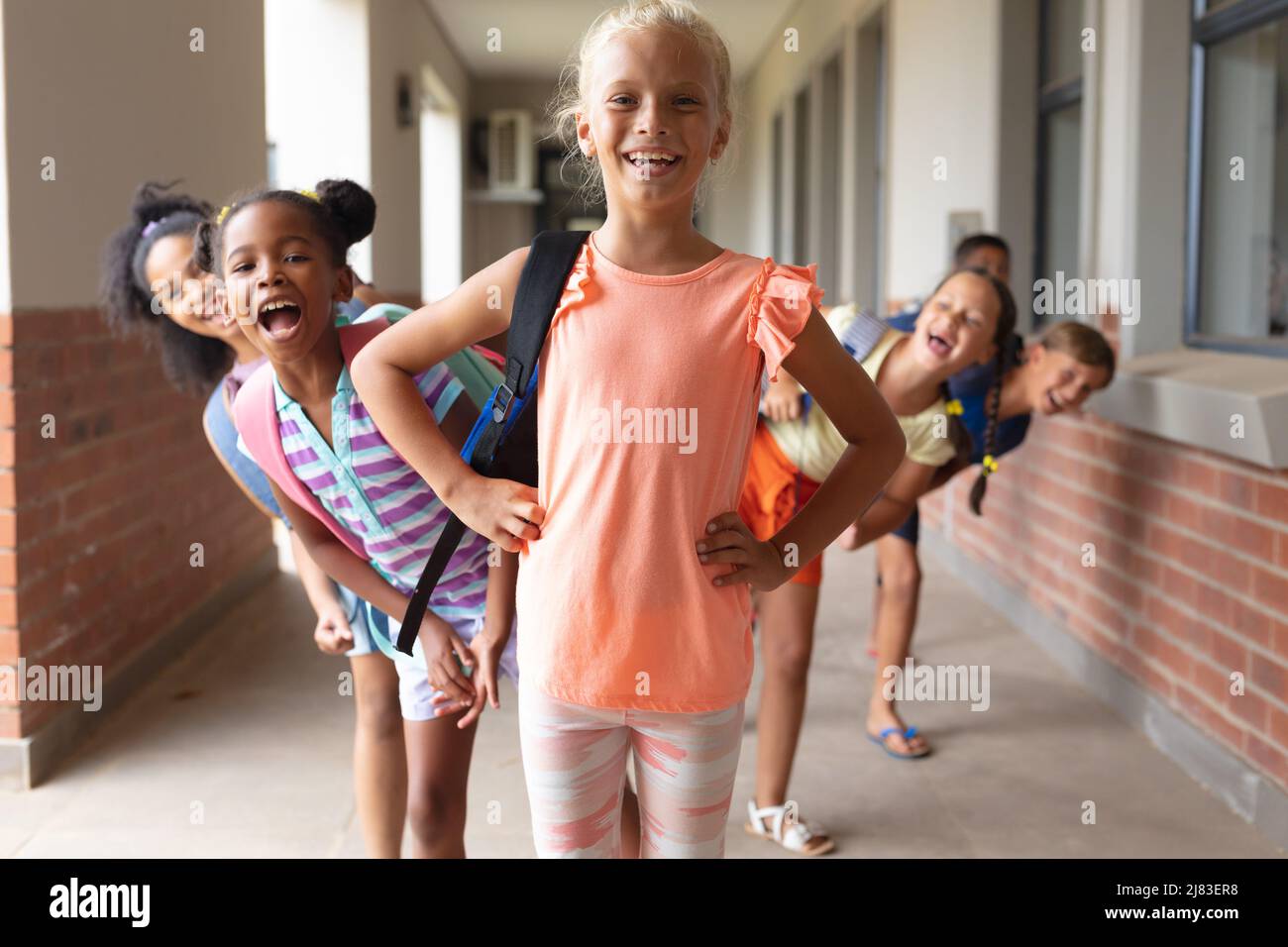 Portrait of smiling playful multiracial elementary school students ...