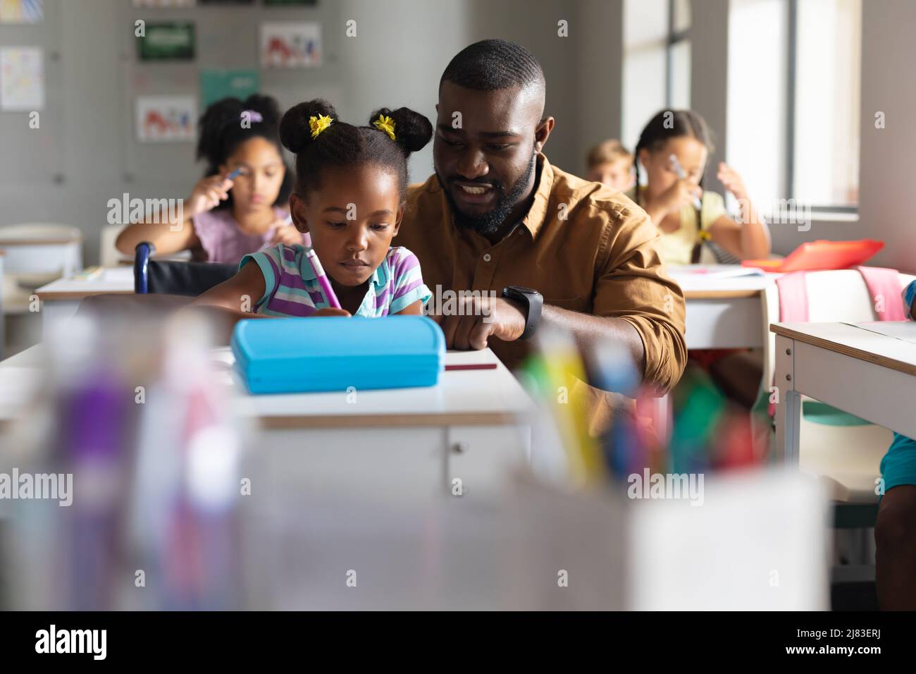 African american young male teacher teaching african american ...
