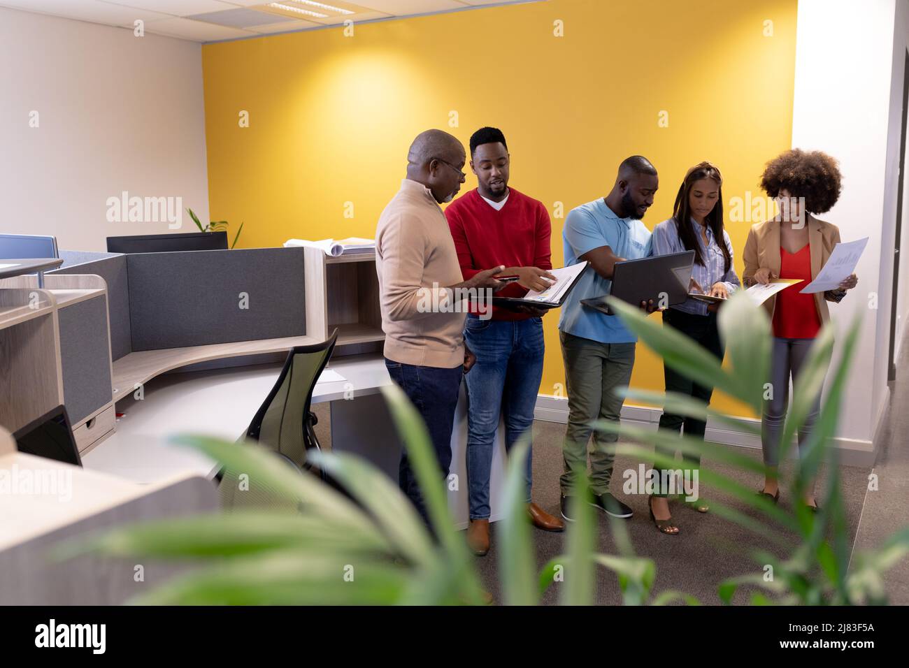 Multiracial business colleagues discussing strategy in modern workplace ...