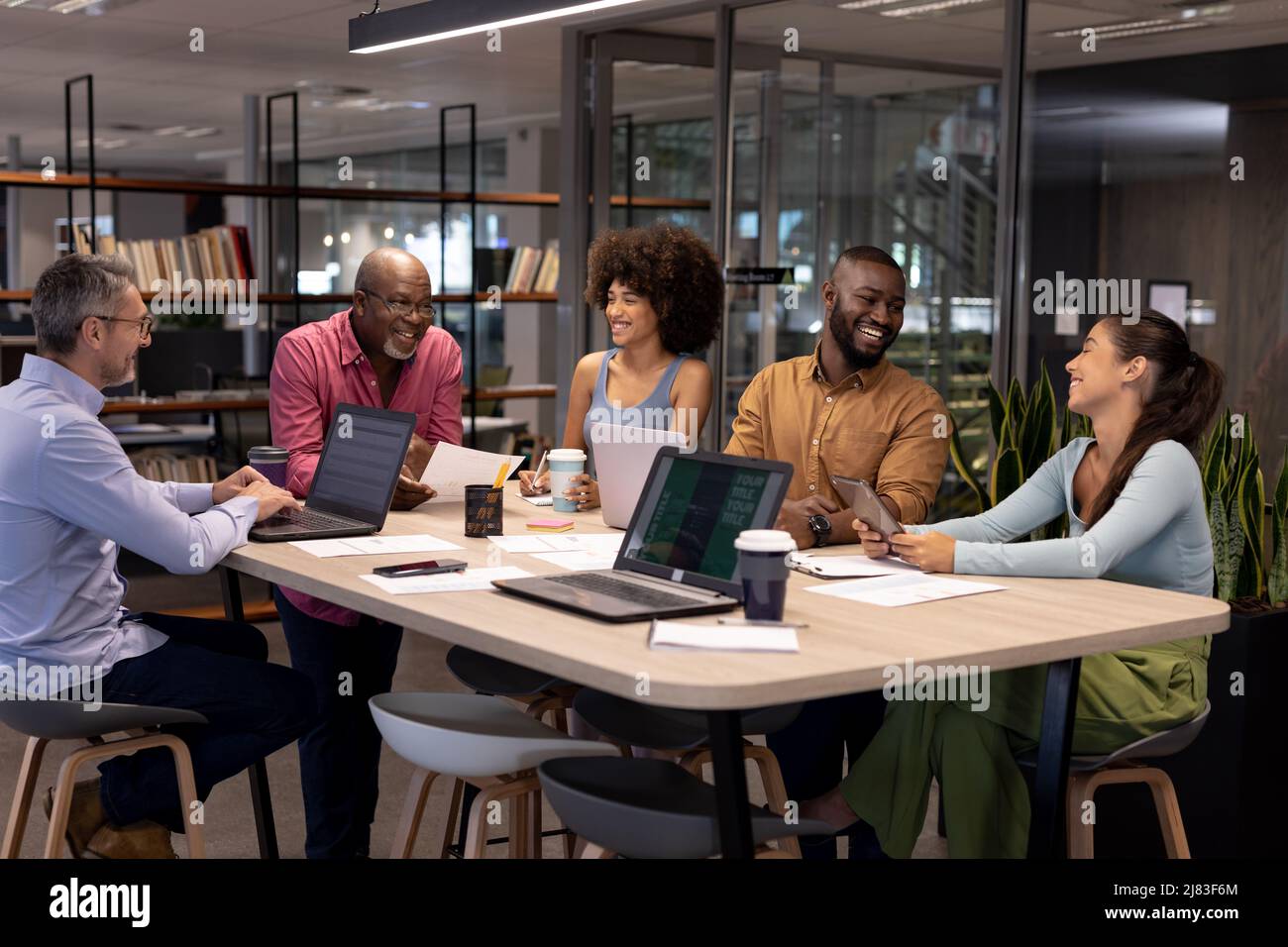 Multiracial colleagues smiling discussing hi-res stock photography and ...