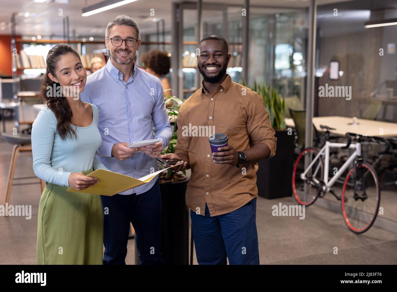 Portrait of smiling multiracial male and female advisors planning ...