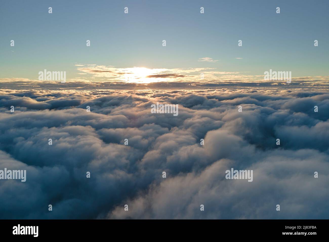 Aerial view from above at high altitude of dense puffy cumulus clouds ...
