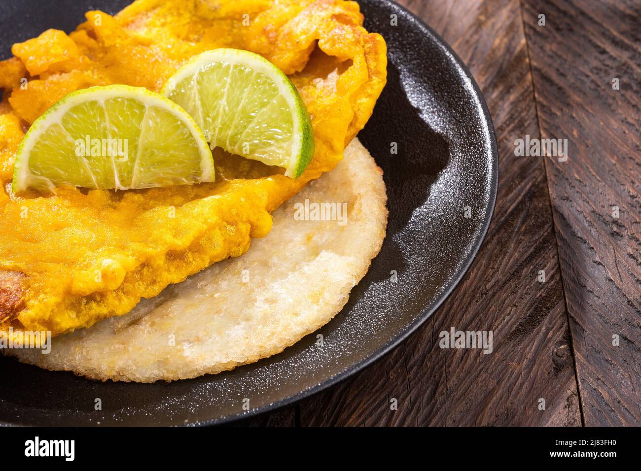 Fish torta with arepa - Colombian street food Stock Photo - Alamy