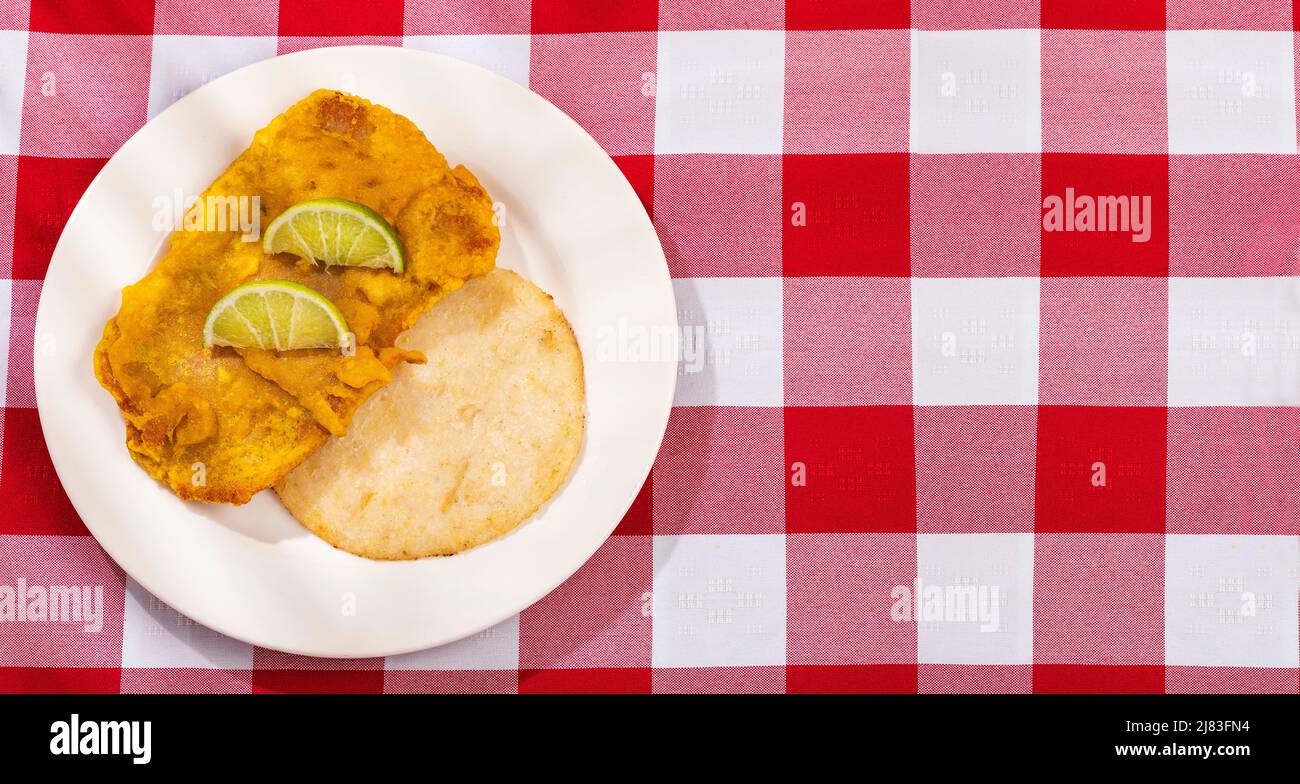Fish torta with arepa - Colombian street food Stock Photo - Alamy