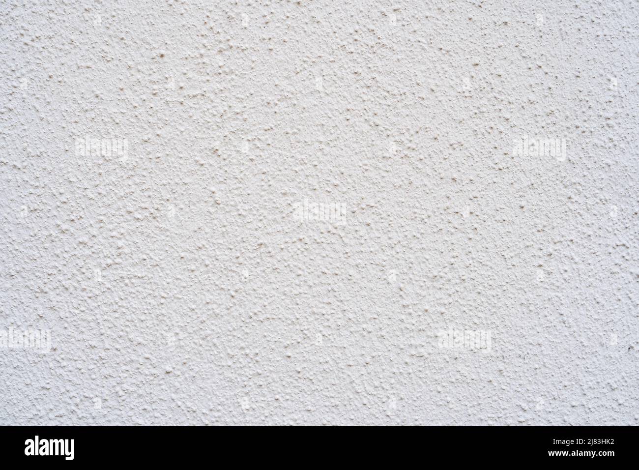 Rough white plaster of a house wall with a medium coarse structure ...