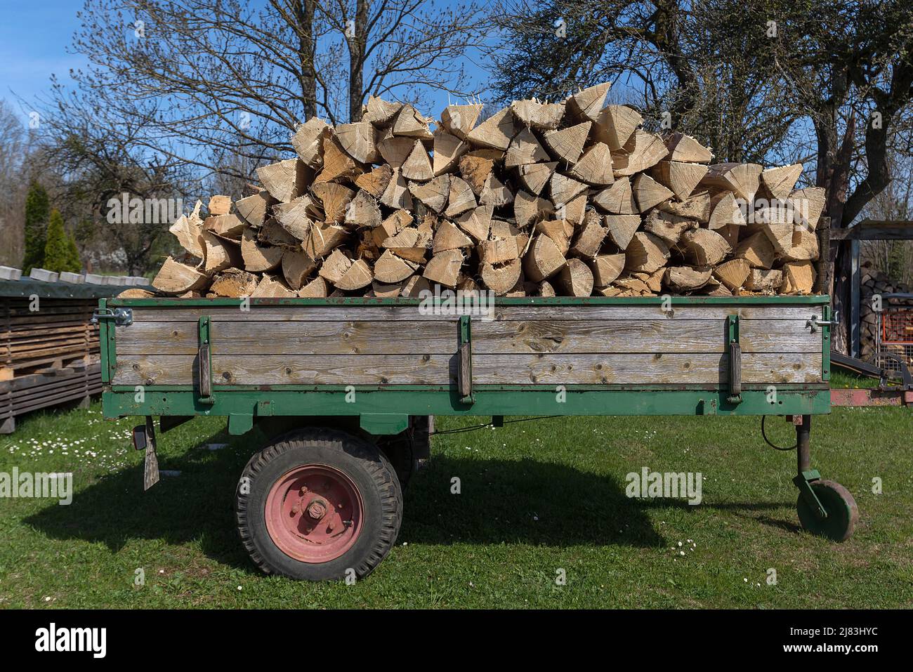 Stack of wood on a trailer, Bavaria, Germany Stock Photo - Alamy
