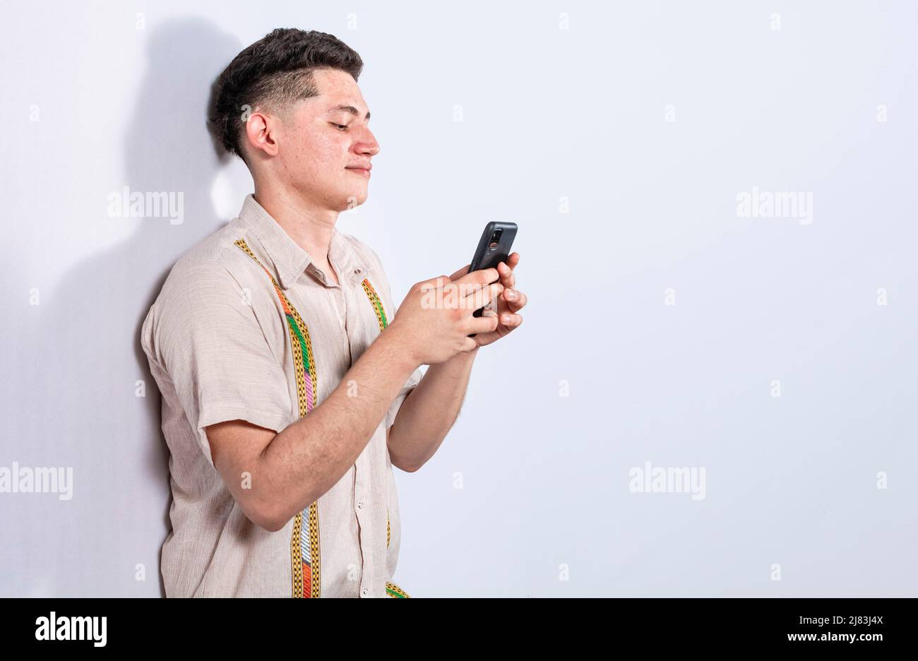 Handsome guy happy with his cell phone on isolated backgrounds, young ...