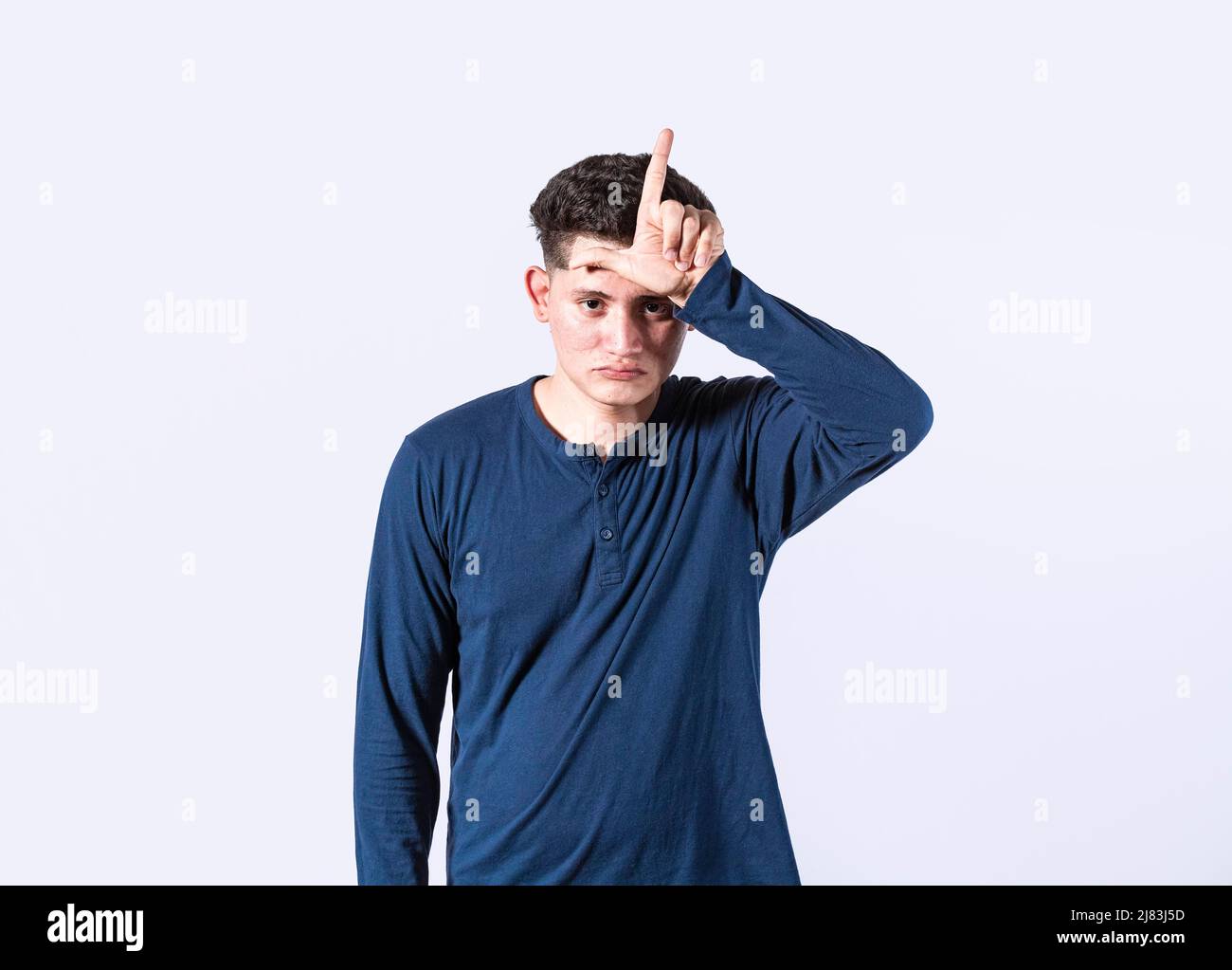 Unhappy man holding hand near forehead showing loser gesture with ...