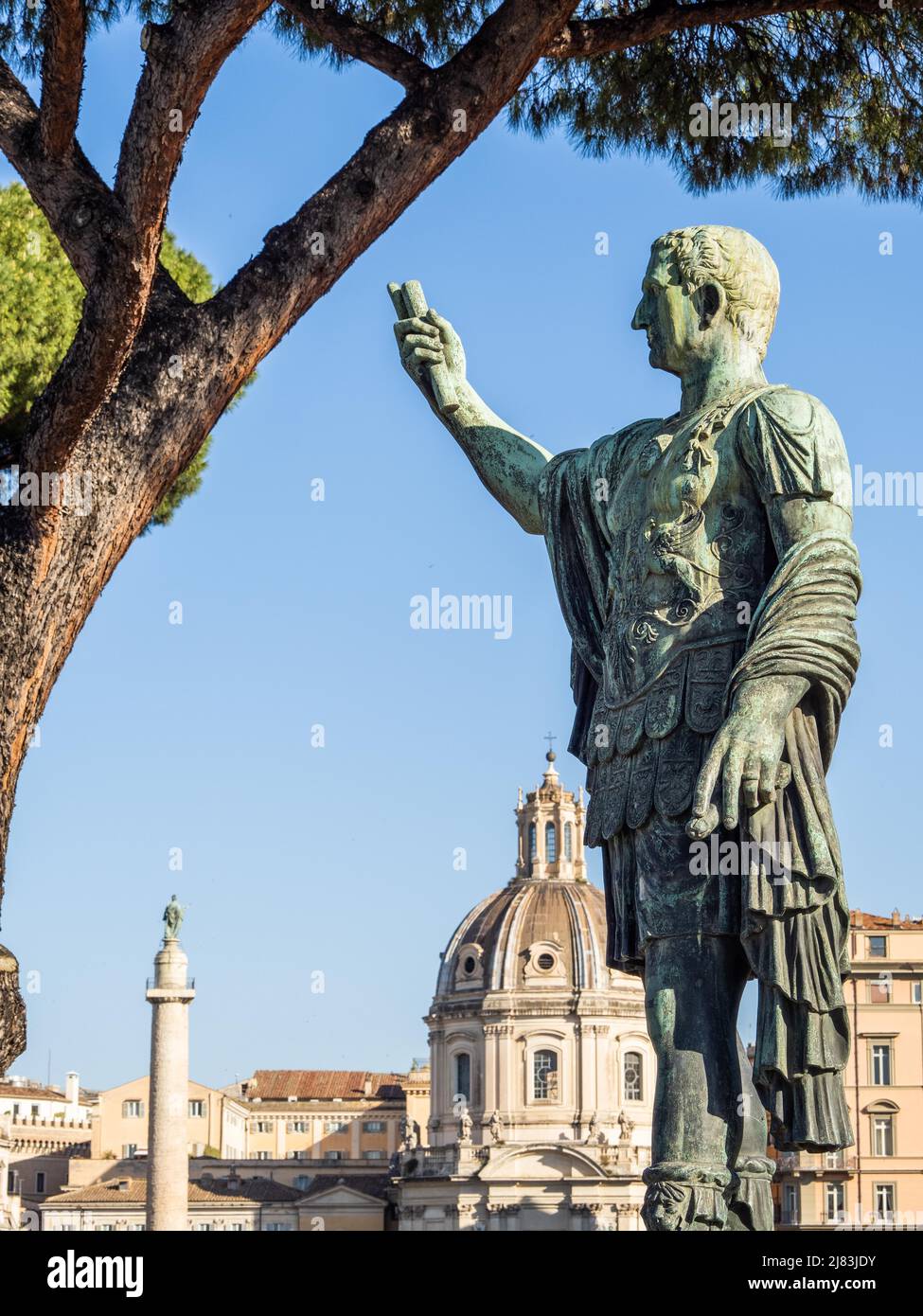Statue of Emperor Trajan, Trajan's Column at the back, Rome, Latium ...