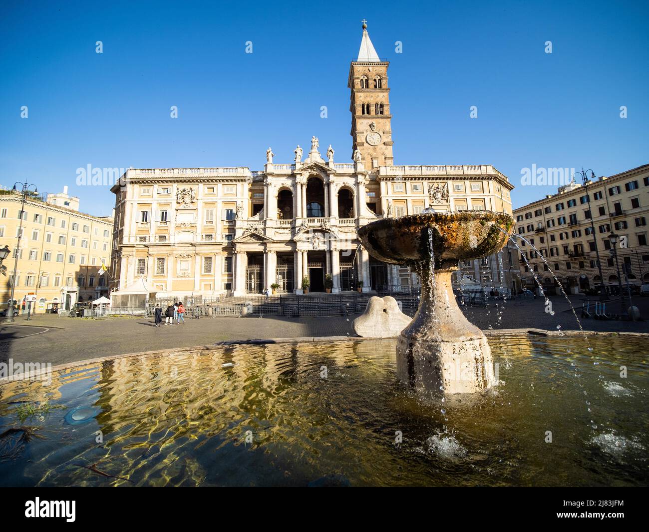 Church of Santa Maria Maggiore in the morning light, fountain in front ...