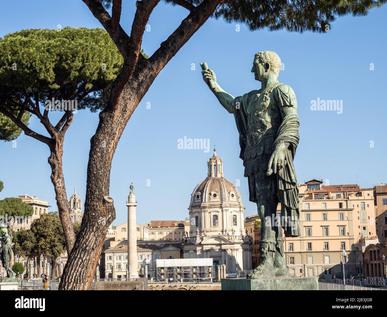 Statue of Emperor Trajan, Trajan's Column at the back, Rome, Latium ...