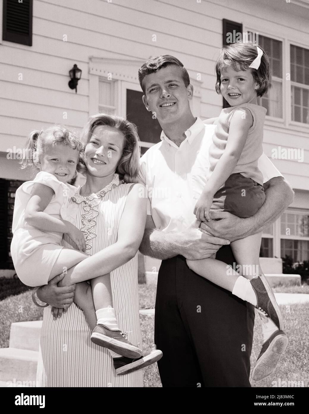 1960s SMILING PORTRAIT FAMILY OF FOUR MOTHER FATHER TWO KIDS DAUGHTERS ...