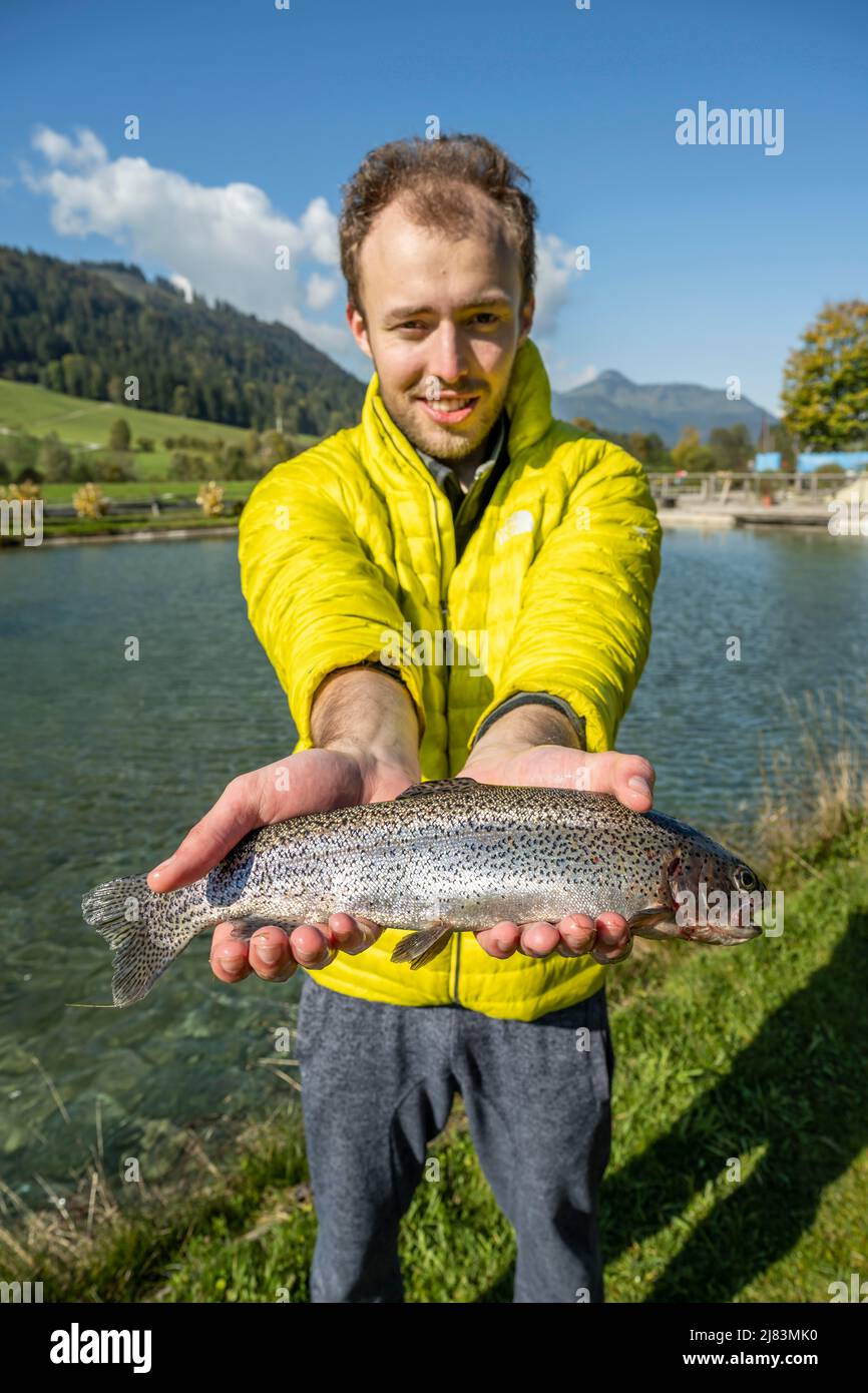 Man proudly holding caught trout, fishing Stock Photo - Alamy