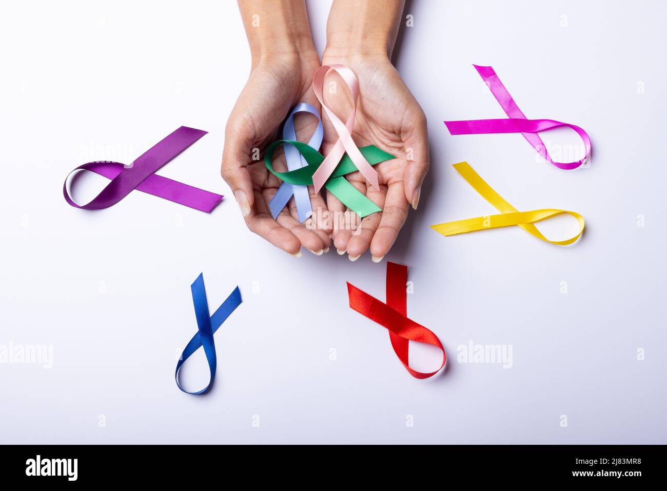 Hands of african american mid adult woman with colorful awareness ...