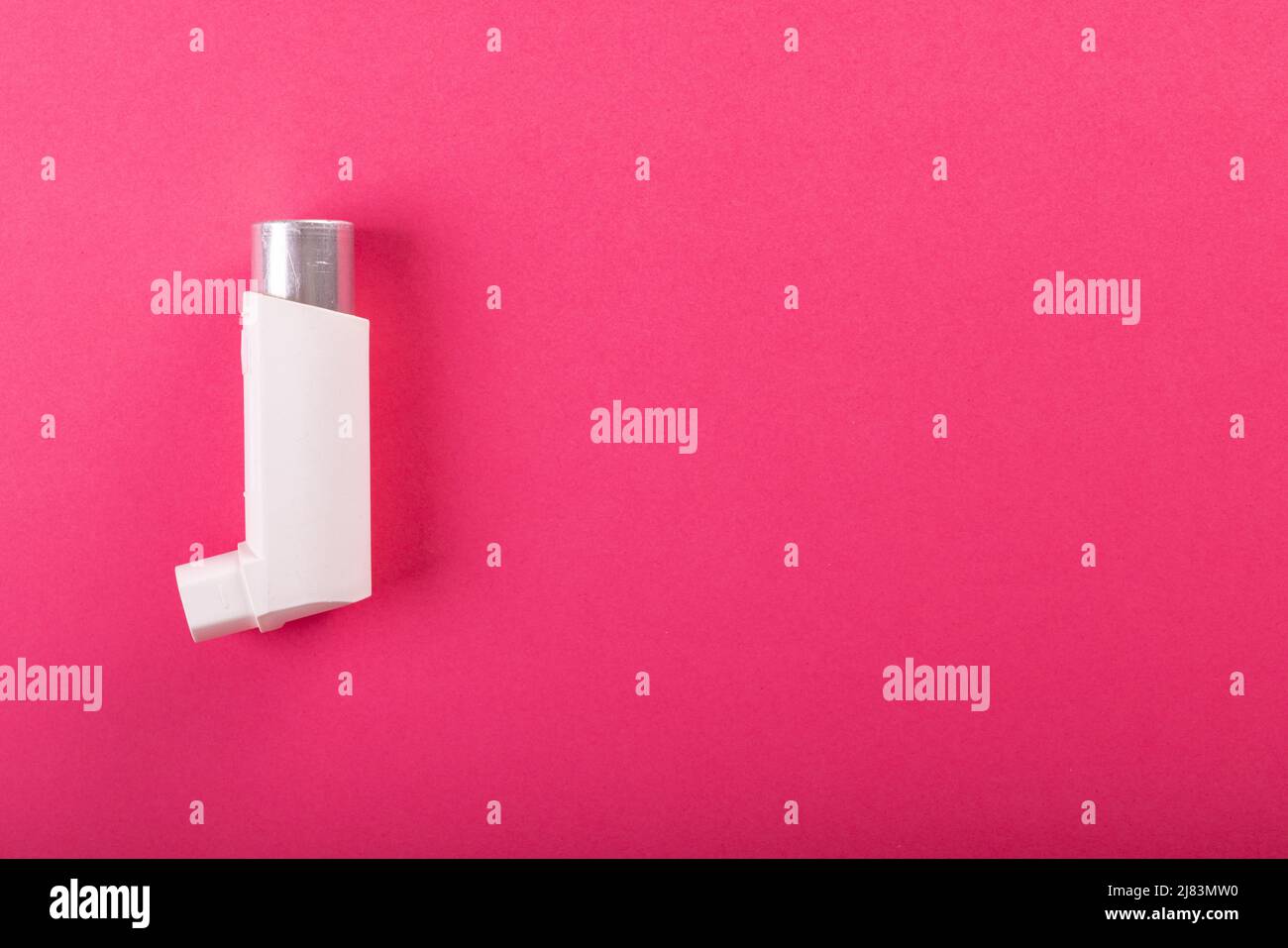 Directly above shot of white asthma inhaler isolated over pink ...