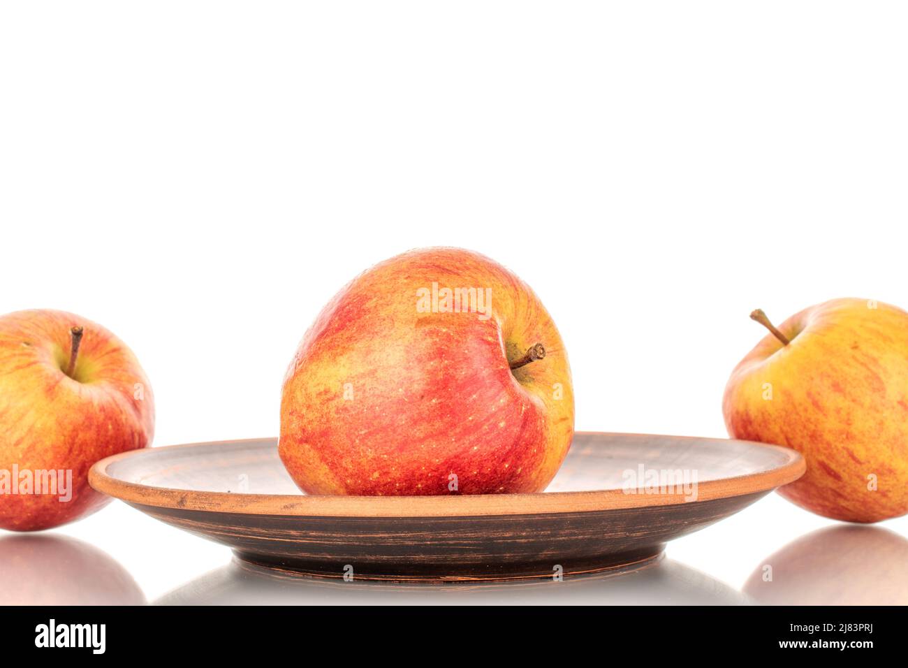Three juicy organic apples with a clay dish, close-up, isolated on a ...