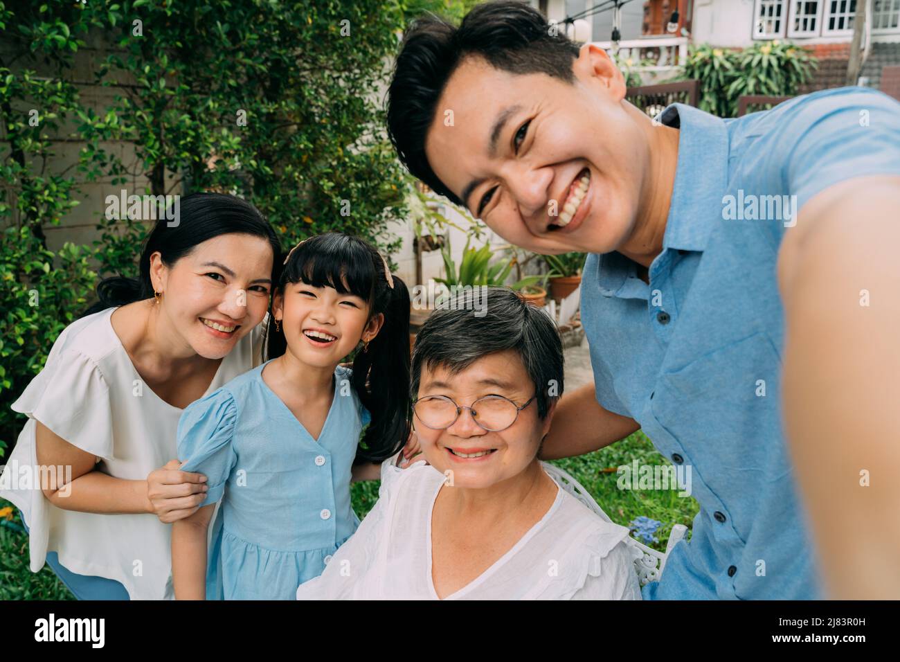 Group of multi-generational Asian family taking a selfie photo together ...