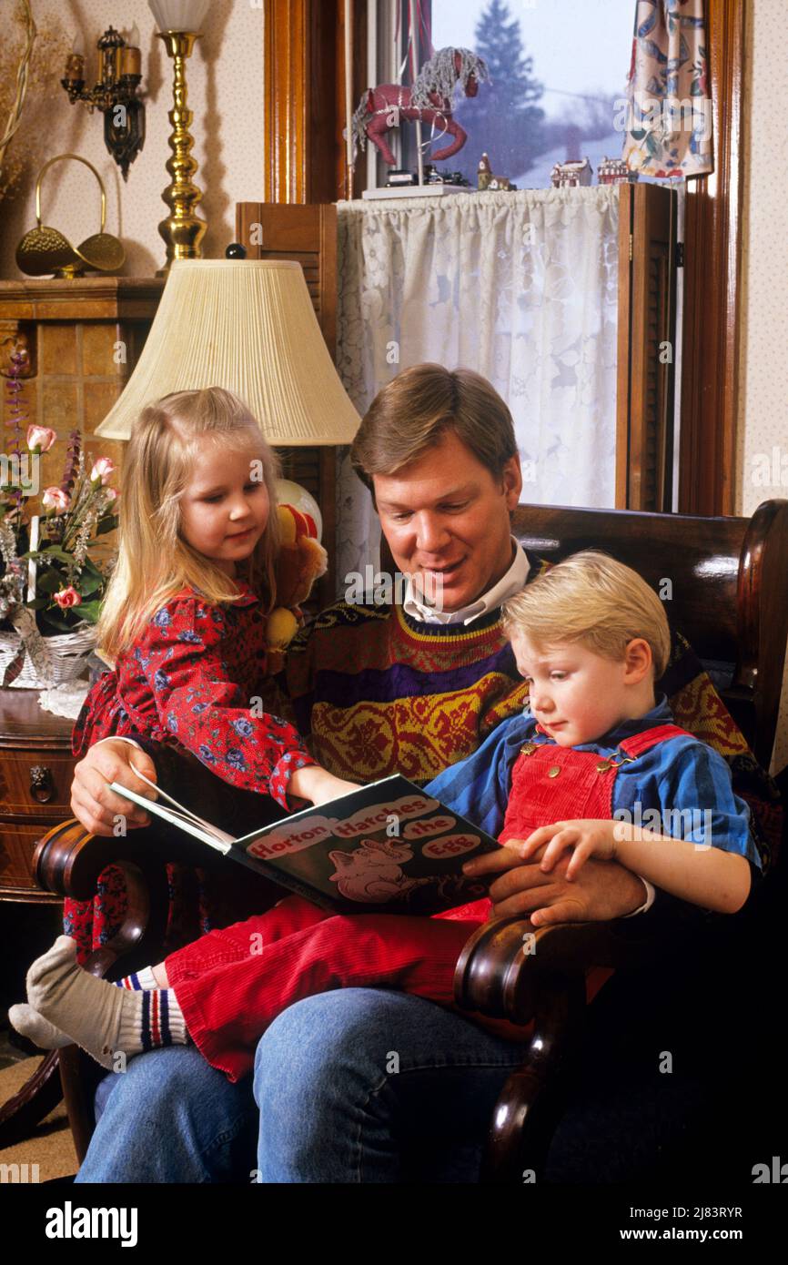 1990s FATHER READING A BOOK TO HIS YOUNG SON AND DAUGHTER - kj13494 ...