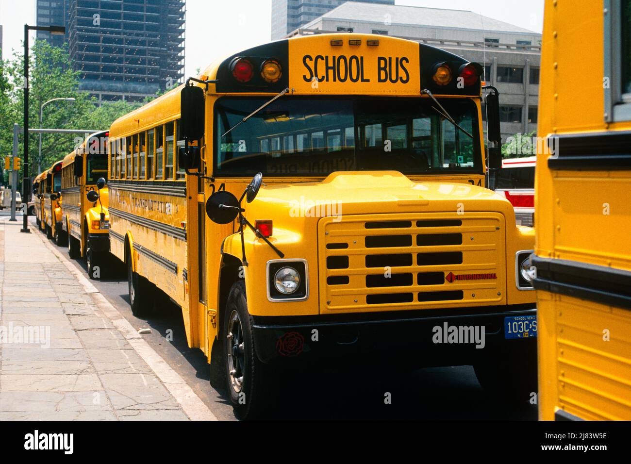 1990s SEVERAL SCHOOL BUSES WAIT PARKED OUTSIDE MUSEUM FOR STUDENTS TO ...