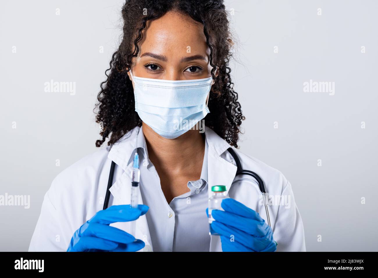 Portrait of african american mid adult female doctor wearing mask ...
