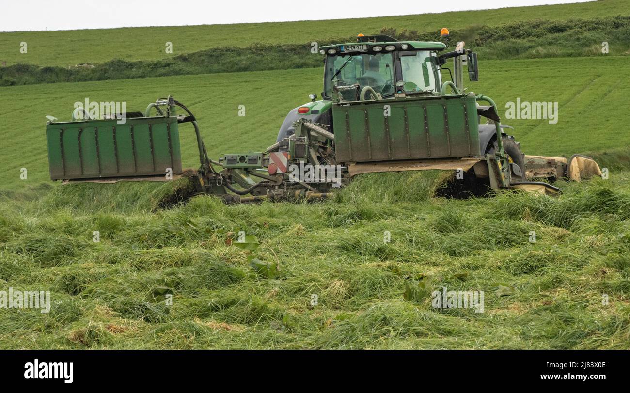 Mowing grass for silage, John Deere 6215R + Krone Mower Stock Photo - Alamy