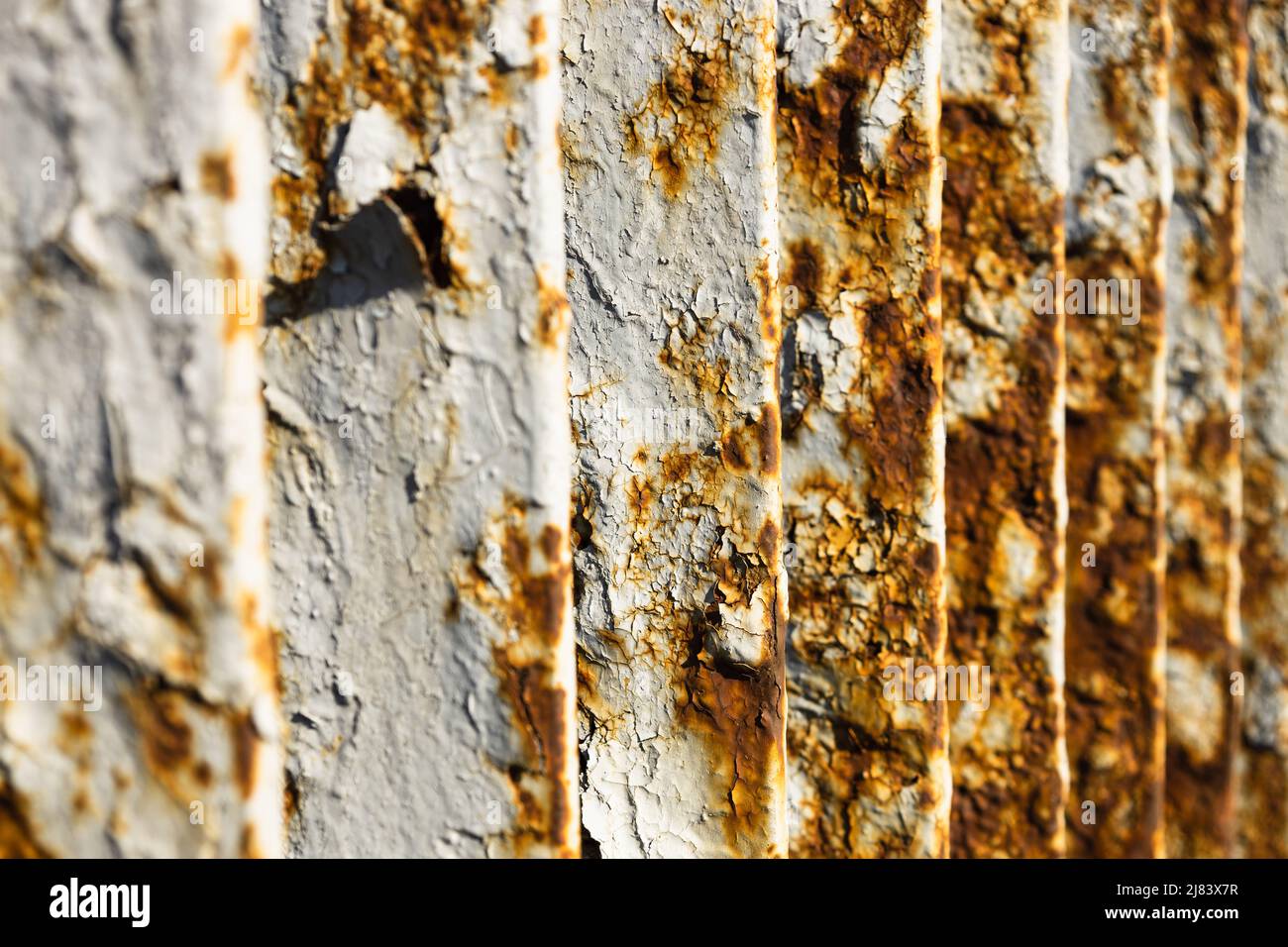 Metal bridge railing with corrosion, rust, deep cracks, and paint ...