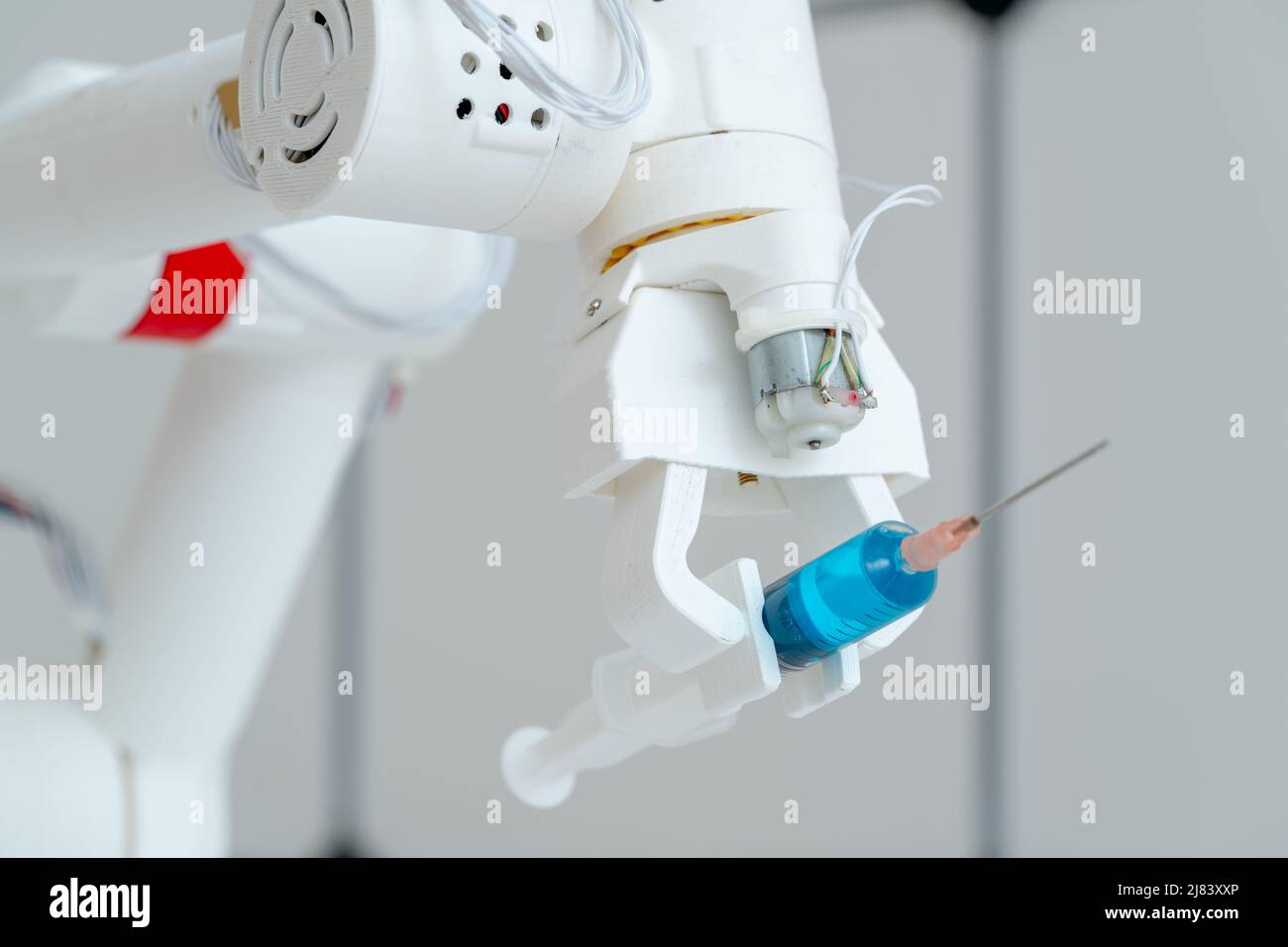 Robot hand with a medical syringe. Future medicine concept using robots ...