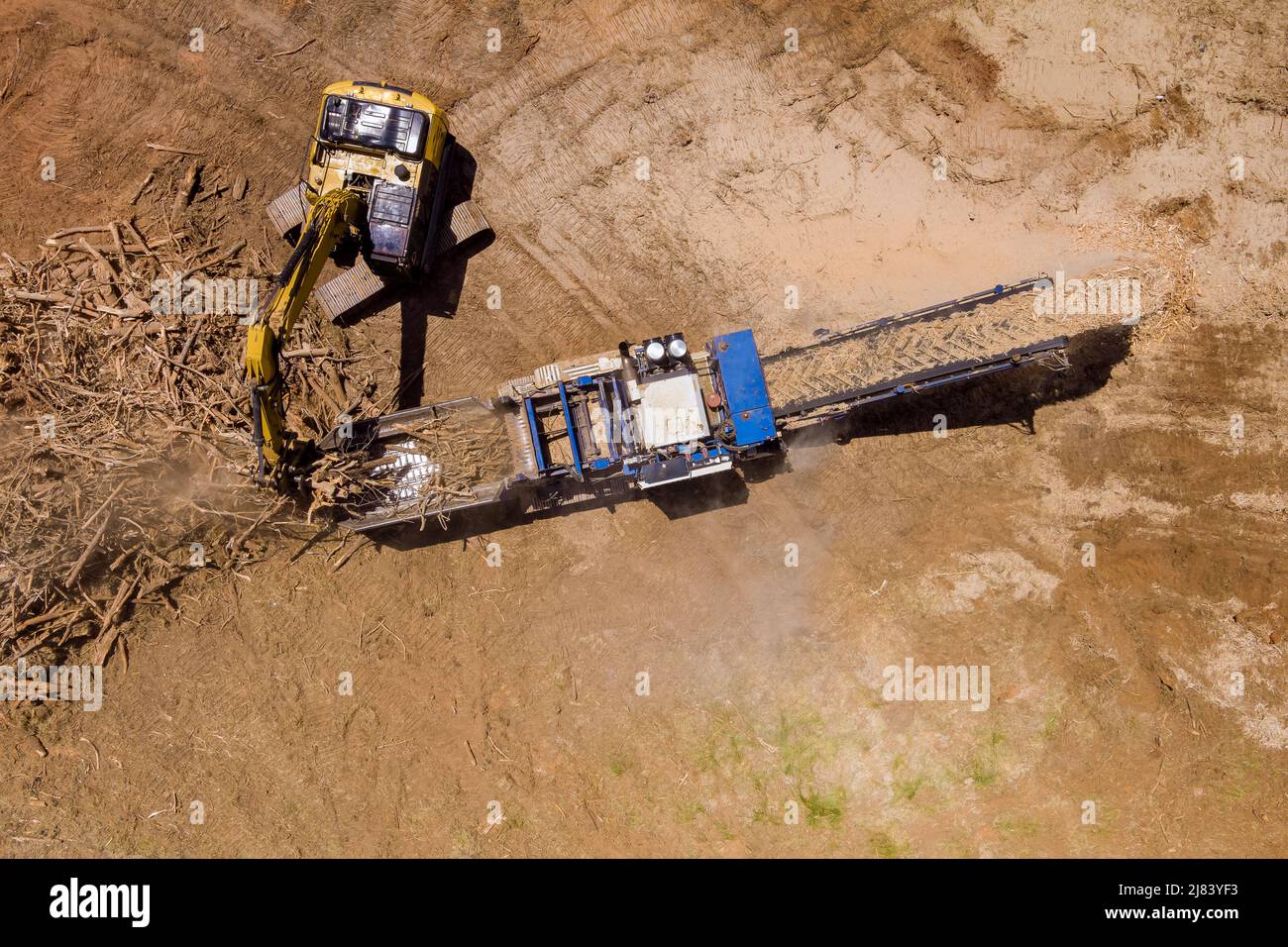 Construction site view with work wood chipping machine the chipper ...