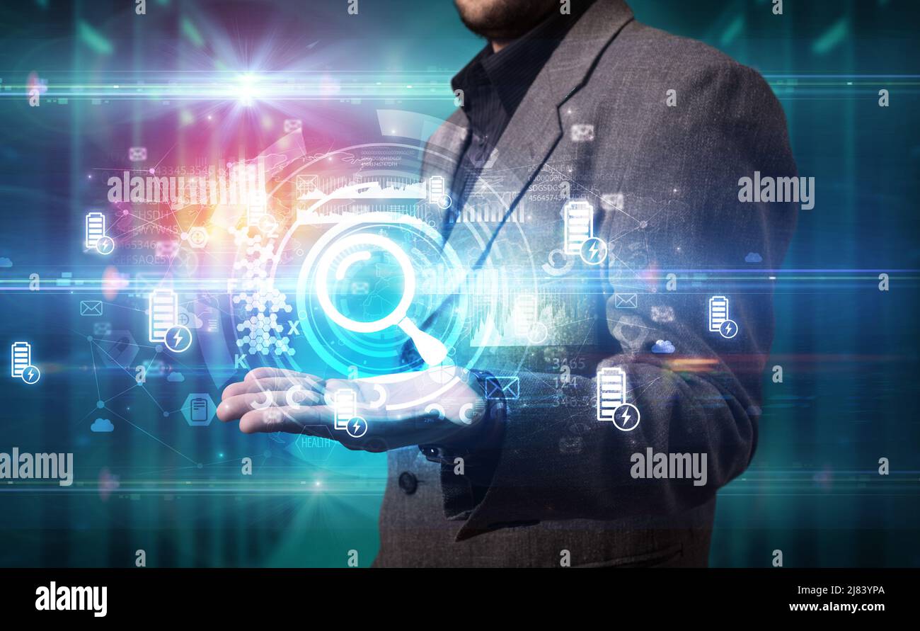 Businessman holding technology icon concept Stock Photo - Alamy