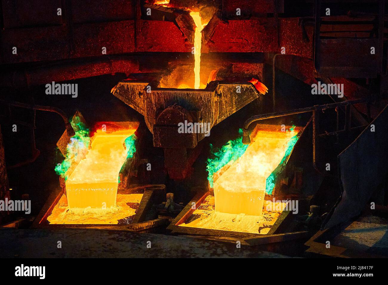Pouring liquid copper metal for anodes into form in workshop Stock ...