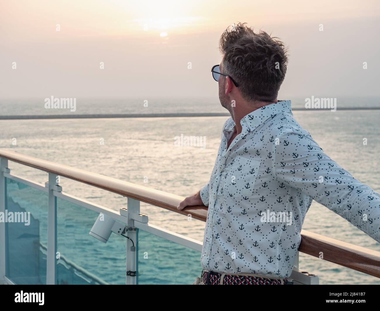 Back of man standing on deck of ship hi-res stock photography and ...