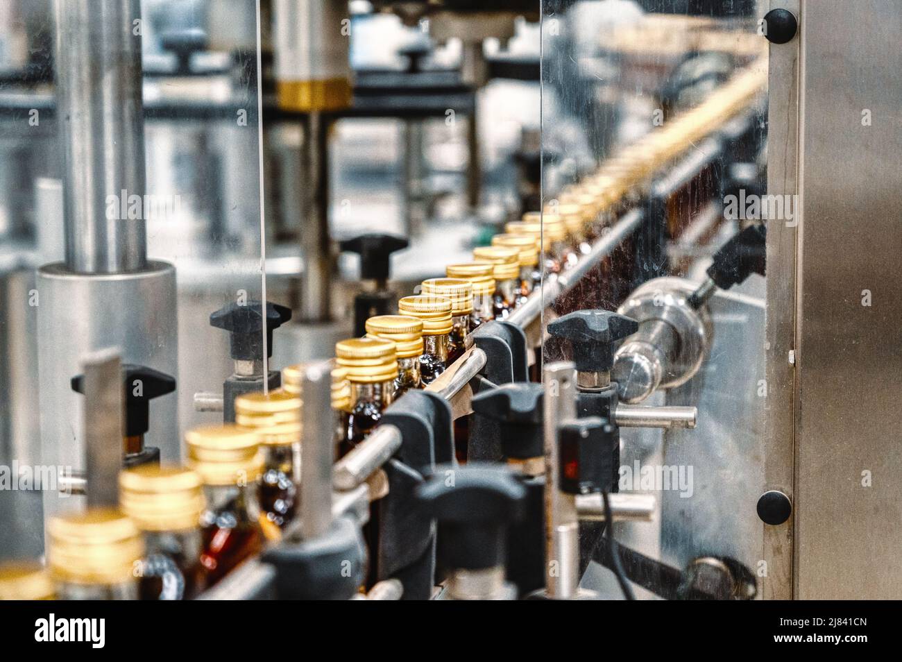 Production line with numerous closed bottles of cognac Stock Photo - Alamy