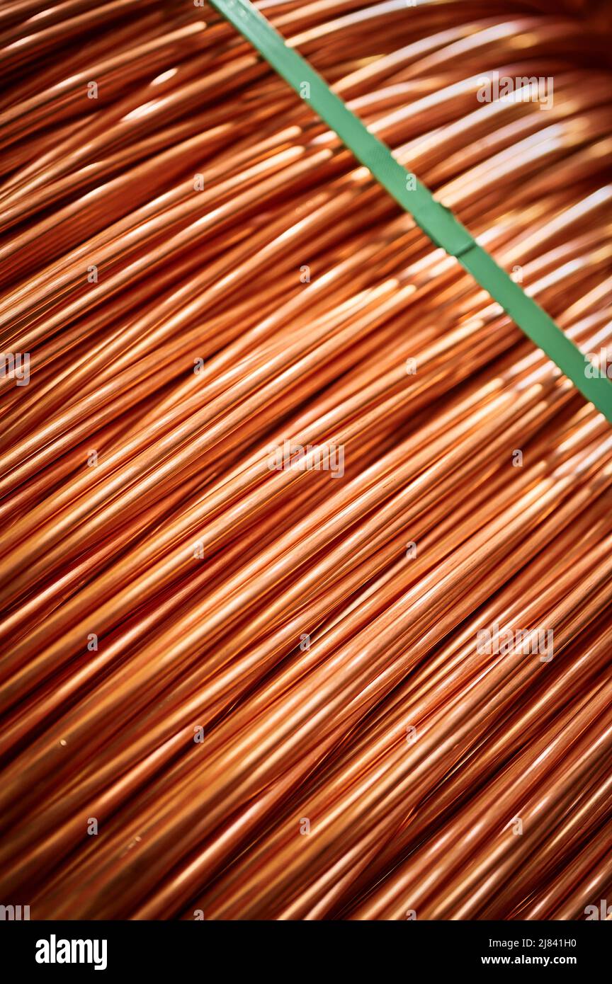 Large bobbin of orange copper wire in light warehouse Stock Photo - Alamy