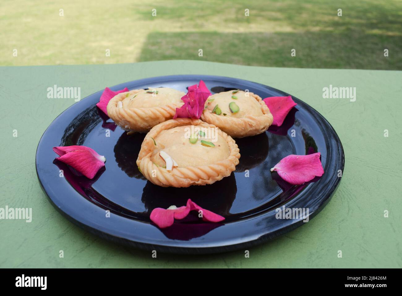 Popular Indian mithai or sweets known as chandrakal. round dumpling ...
